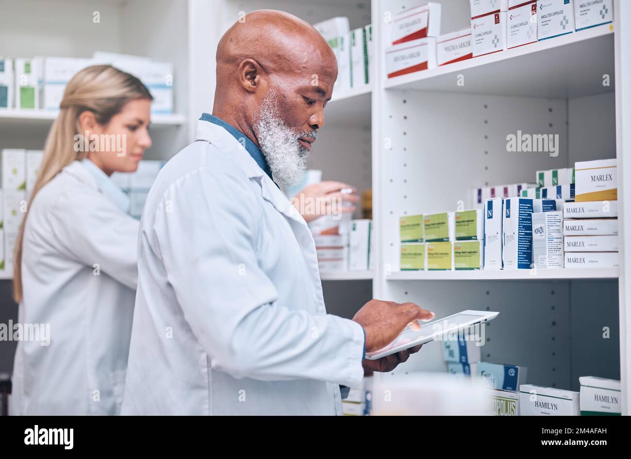 Pharmacy, stock and digital tablet for inventory by man and woman ...
