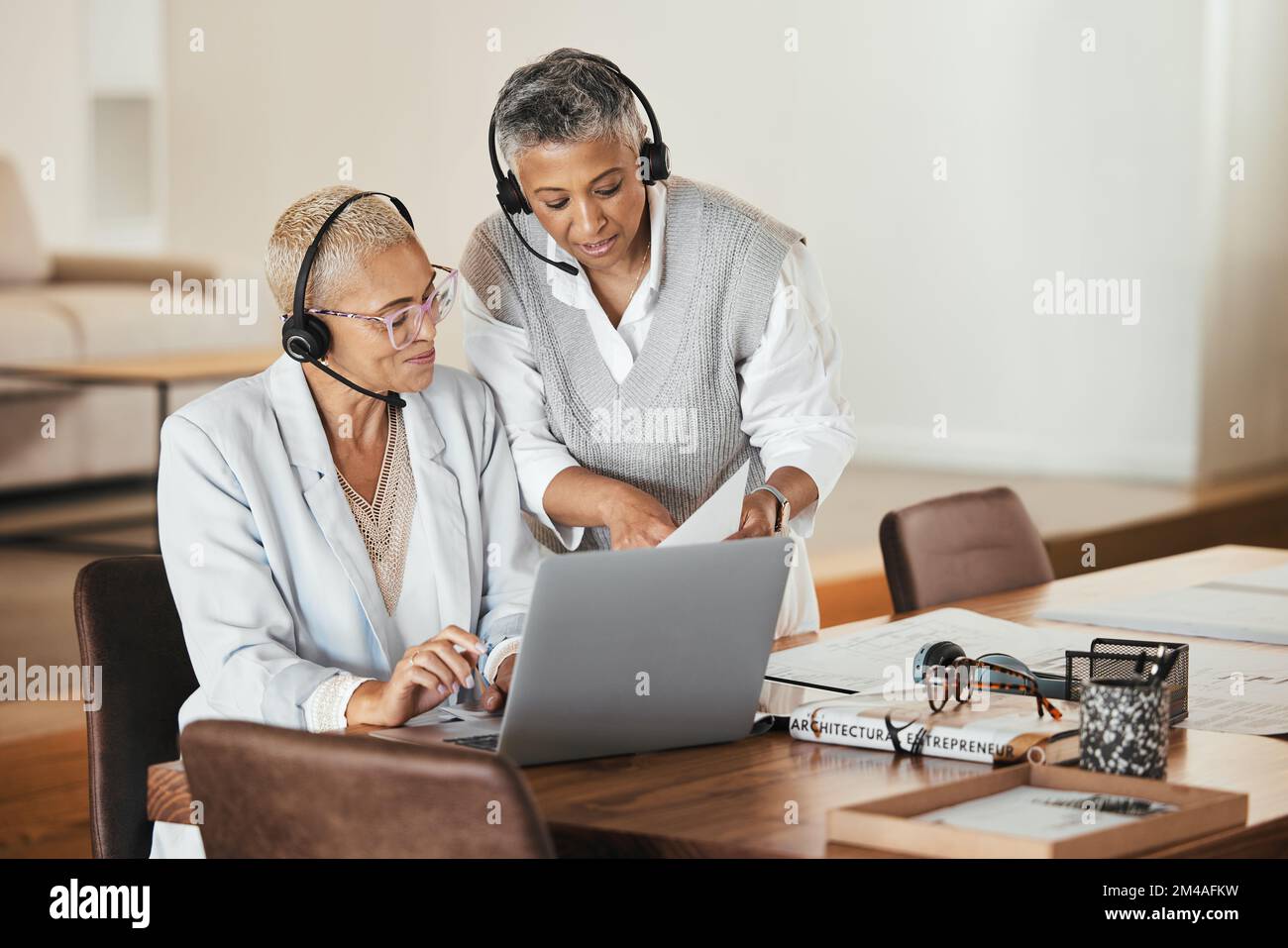 Laptop, consulting and woman help mentor while doing presentation in a ...