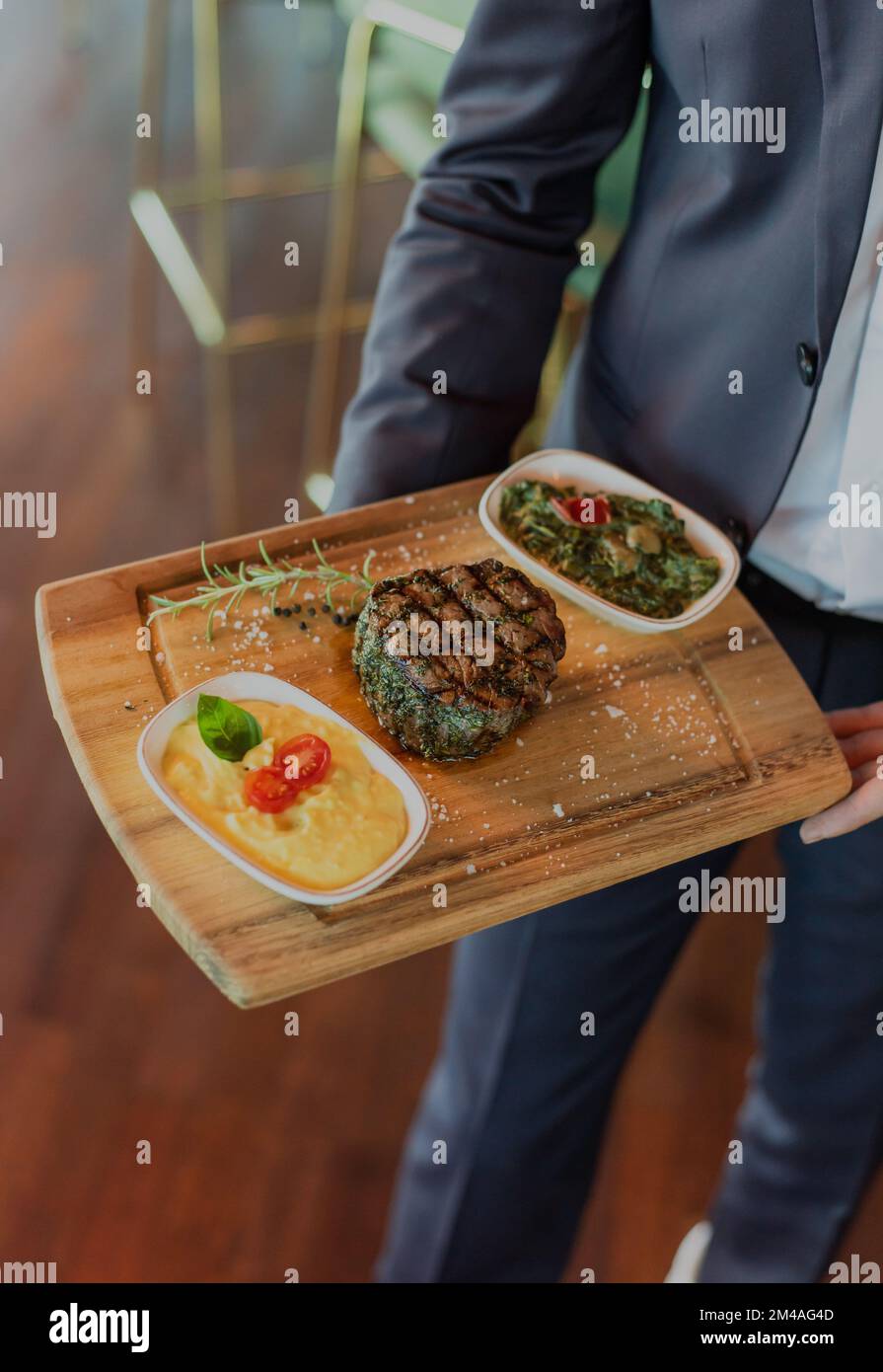 A vertical shot of a tasty steak prepared in the ambient of a high ...