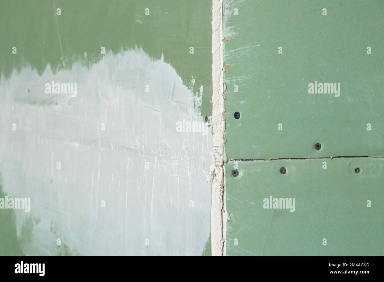 plasterboard green on the wall, room repair Stock Photo - Alamy