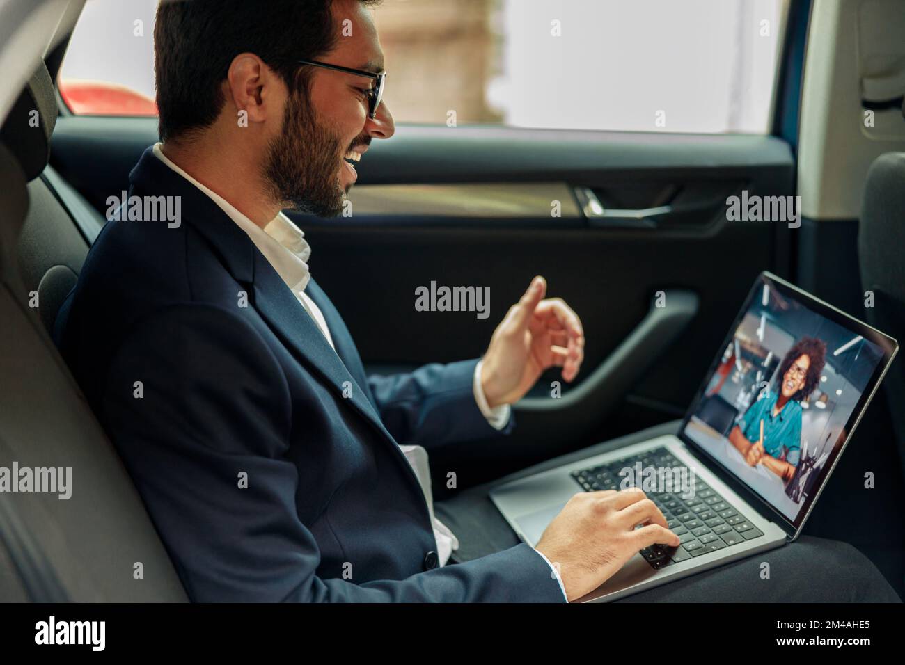Businessman have a business meeting via video call while riding in car ...