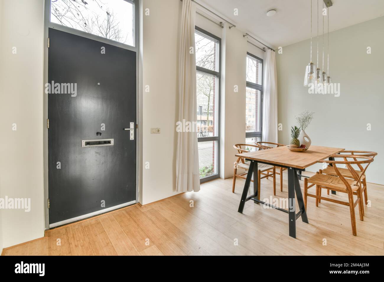 Interior of the dining area next to the door to the outside and a vase ...