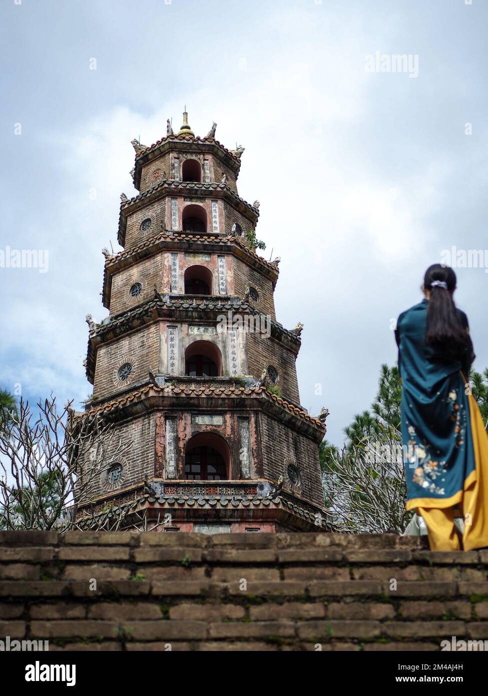 Vietnamese woman in front of Thiên Mụ Temple Stock Photo - Alamy