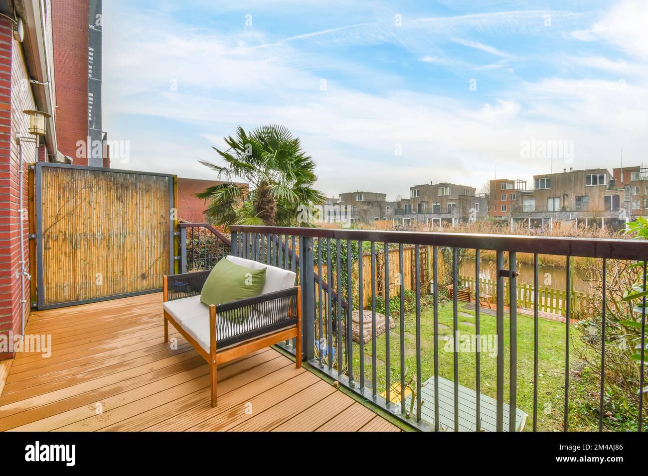 A spacious balcony with wooden floors and a descent to the backyard of ...