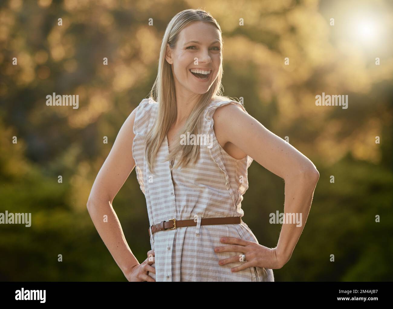 Portrait, happy and woman relax in park, smile and cheerful while ...