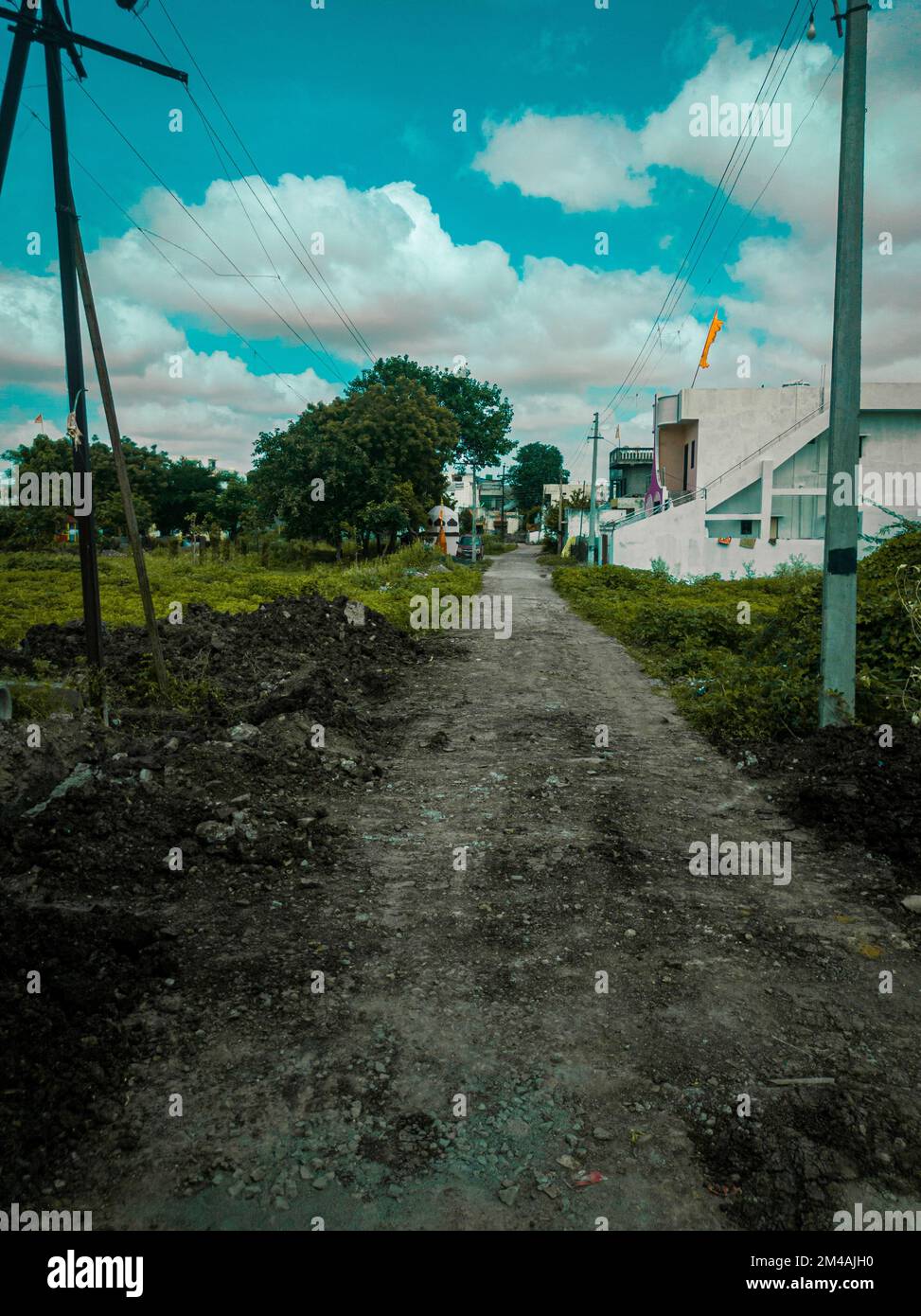 A vertical shot of a destroyed path with earth piled on the sides in a ...