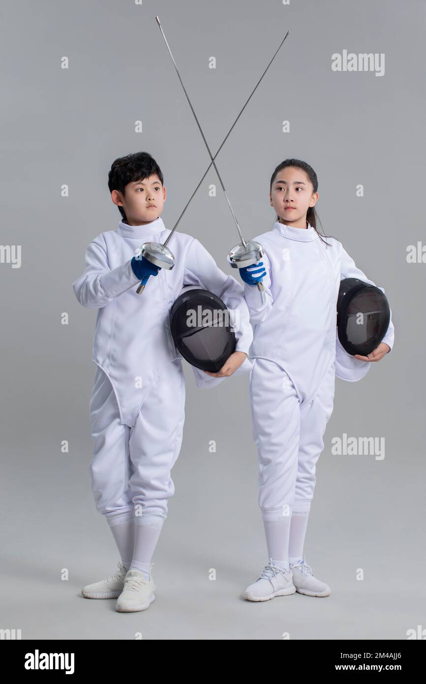 Cute Chinese girl and boy in fencing suit Stock Photo - Alamy