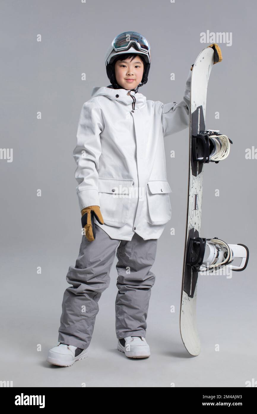 Cheerful Chinese boy with snowboard Stock Photo - Alamy