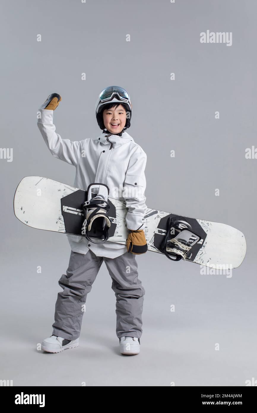 Cheerful Chinese boy with snowboard Stock Photo - Alamy