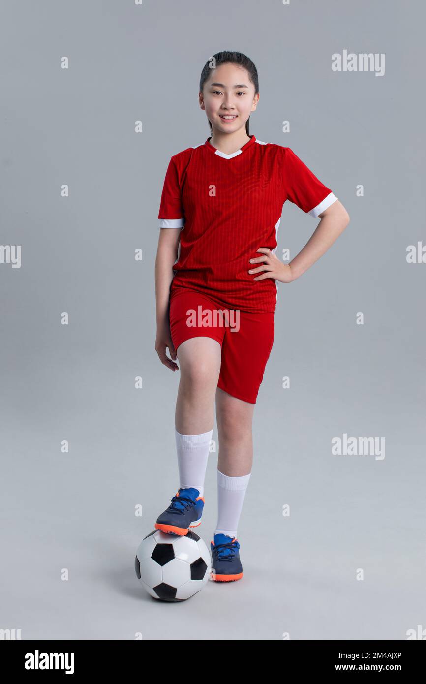 Studio shot of cute Chinese soccer player Stock Photo - Alamy