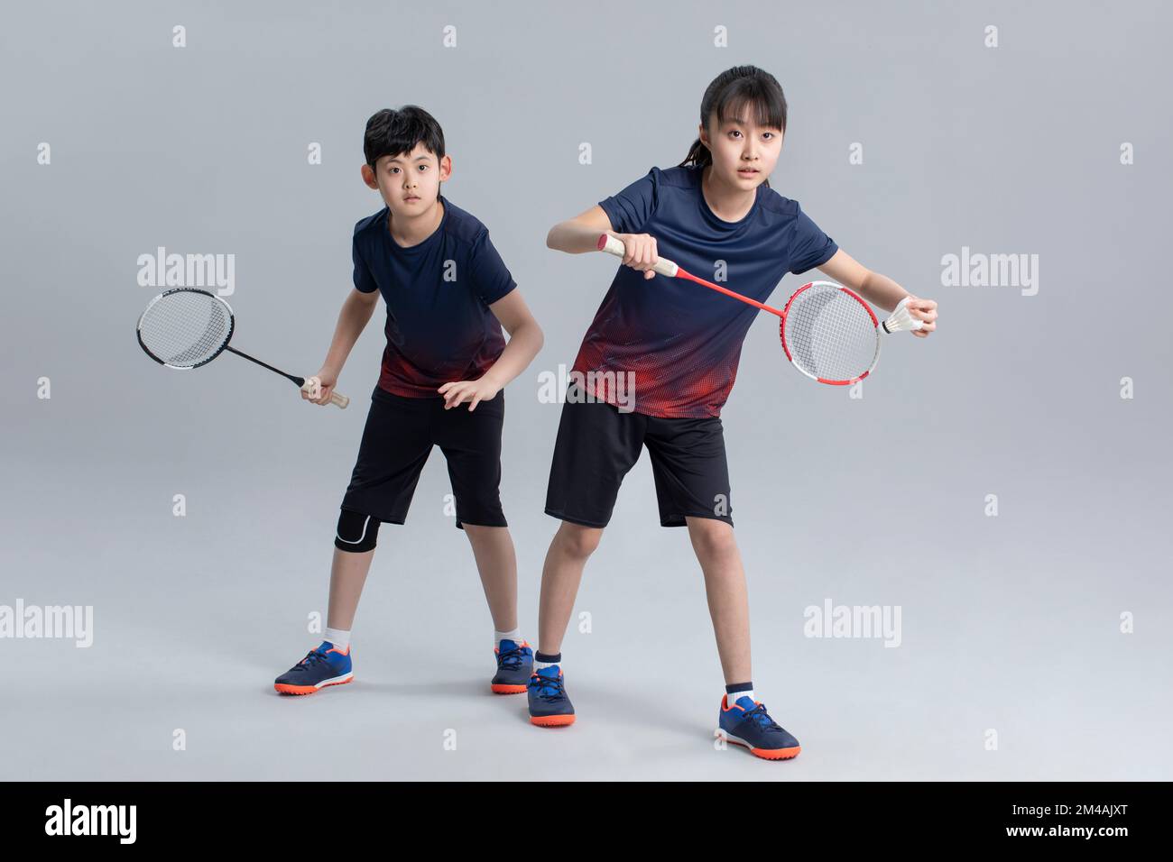 Cheerful Chinese girl and boy playing badminton Stock Photo - Alamy