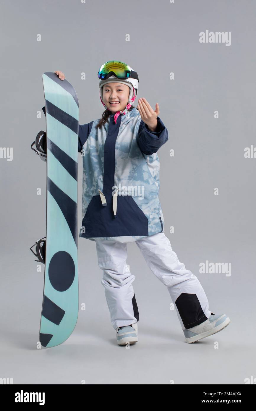 Cheerful Chinese girl with snowboard Stock Photo - Alamy