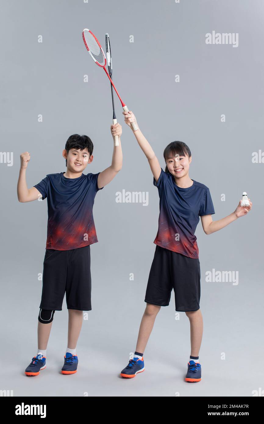 Cheerful Chinese girl and boy playing badminton Stock Photo - Alamy