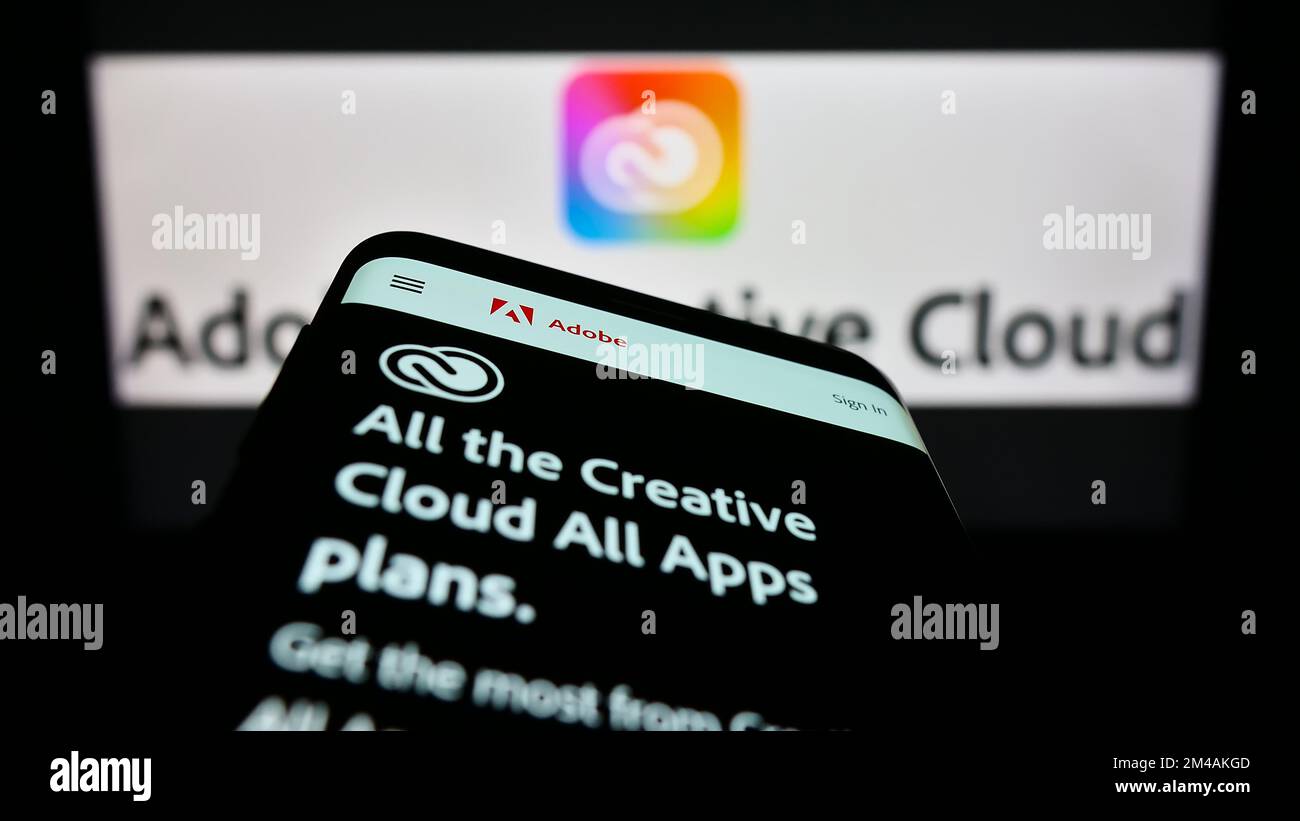 Mobile phone with website of software Adobe Creative Cloud on screen in ...