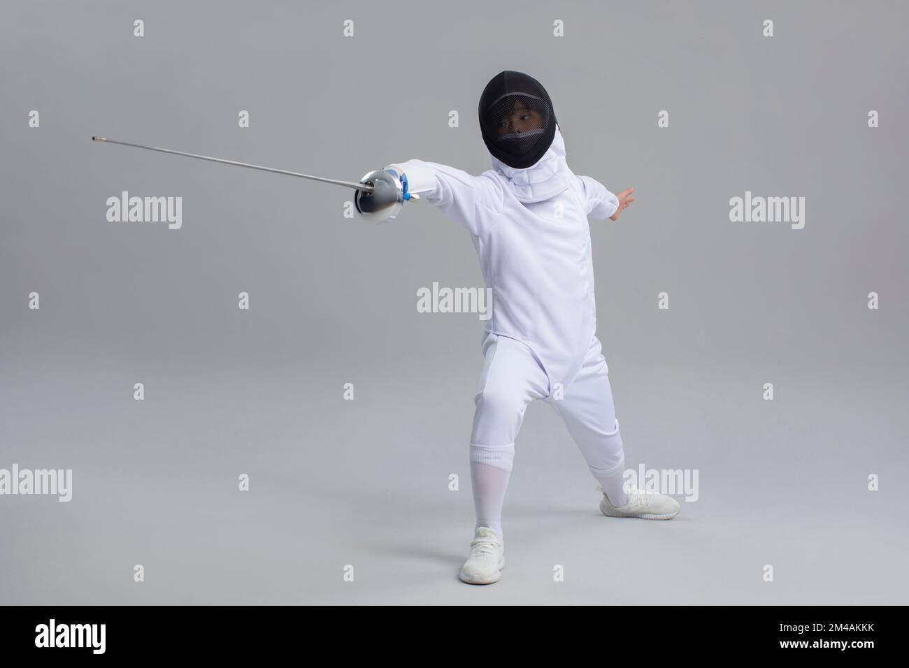 Cute Chinese boy in fencing suit Stock Photo - Alamy
