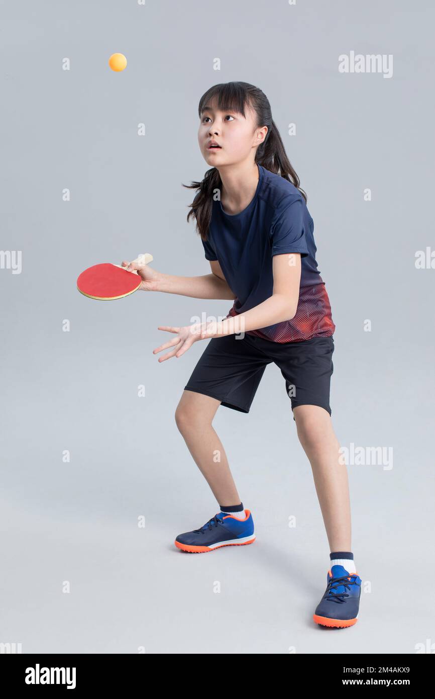 Cheerful Chinese girl playing table tennis Stock Photo - Alamy