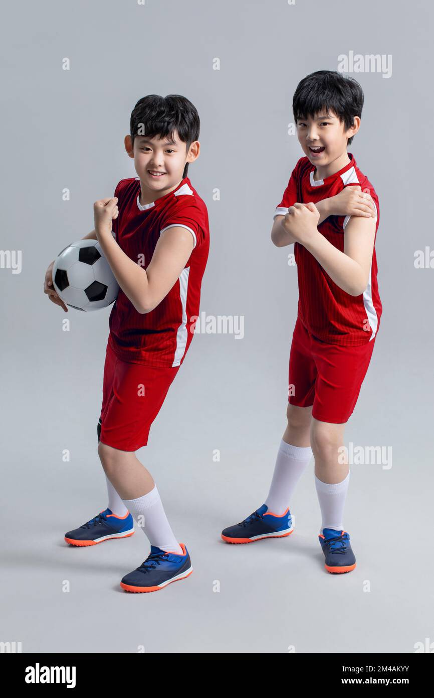 Studio shot of cute Chinese soccer players Stock Photo - Alamy