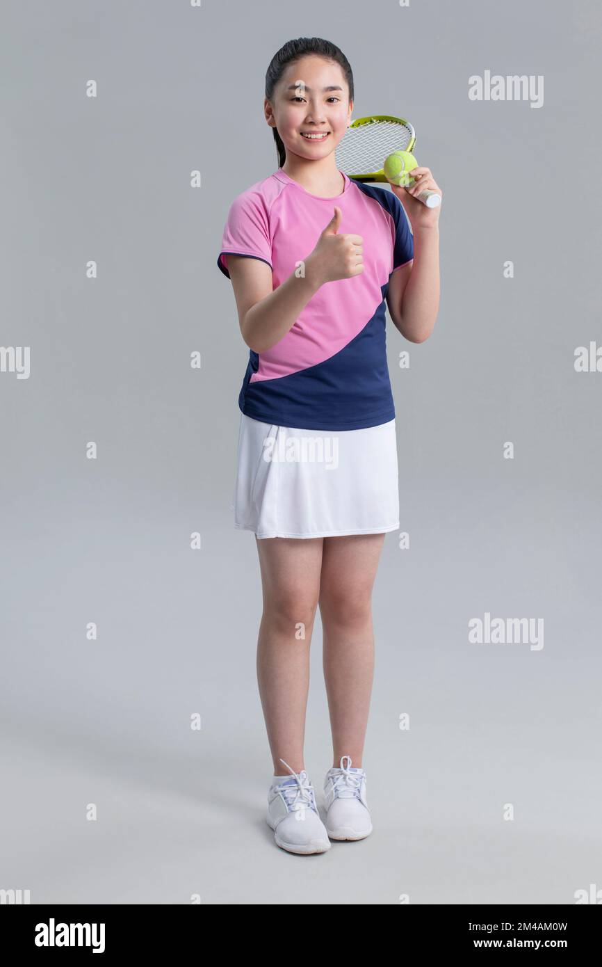 Cheerful Chinese girl playing tennis Stock Photo - Alamy