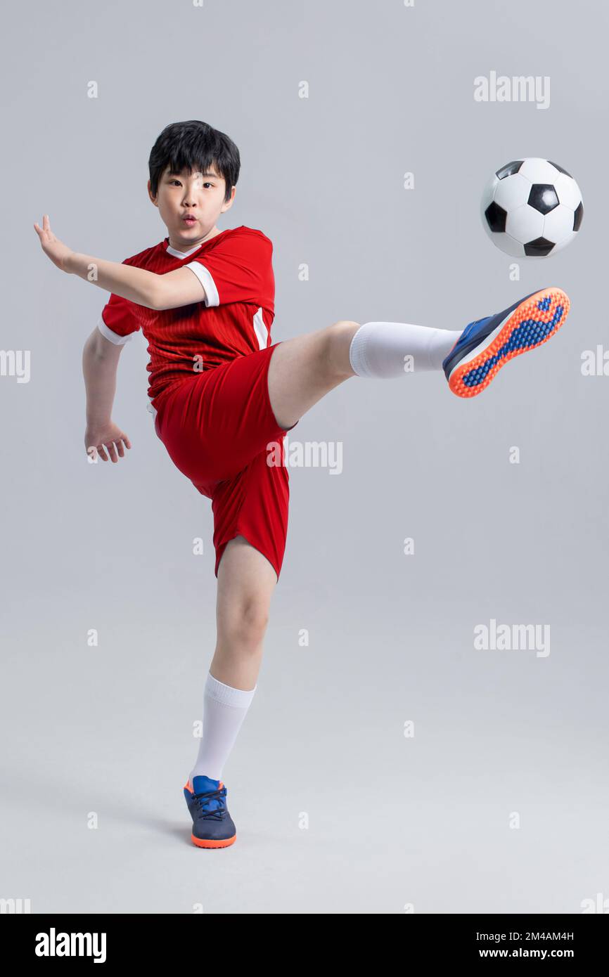 Cheerful Chinese boy playing soccer Stock Photo - Alamy Cheerful Chinese boy playing soccer Stock Photo - Alamy