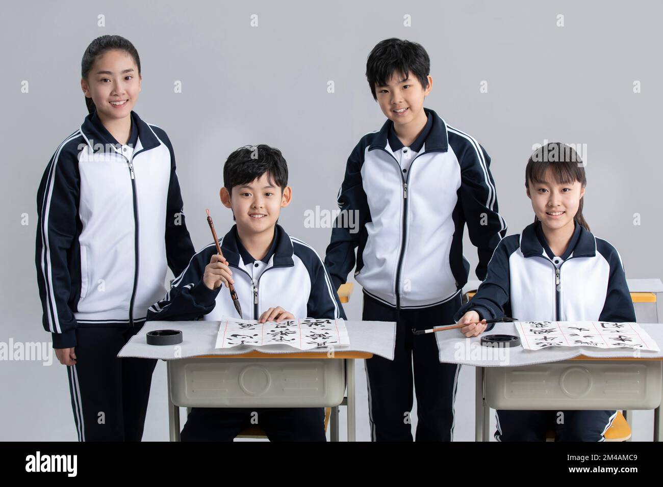 Chinese students practicing calligraphy in classroom Stock Photo - Alamy