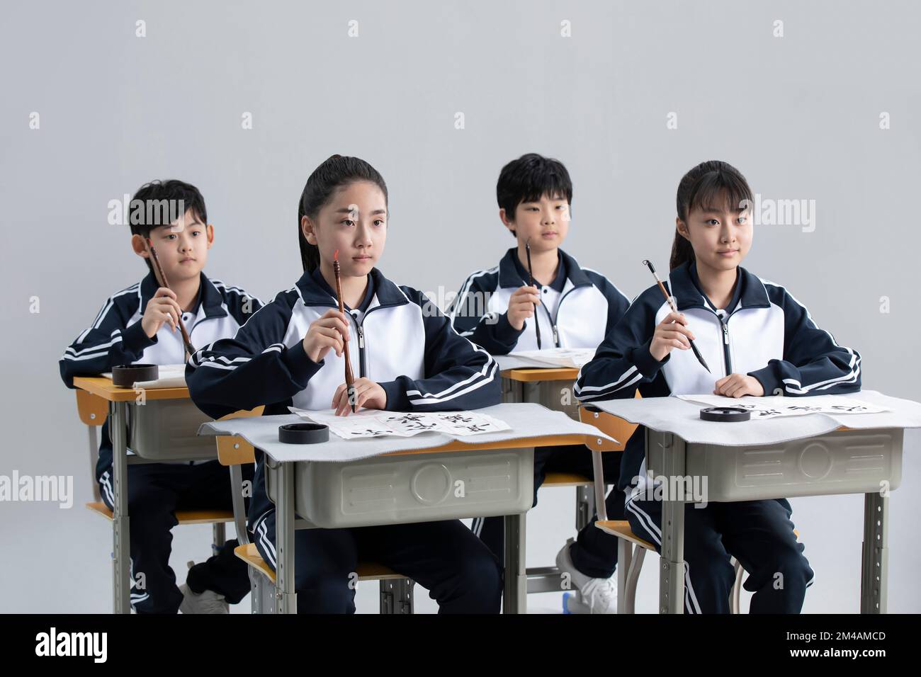 Chinese students practicing calligraphy in classroom Stock Photo - Alamy