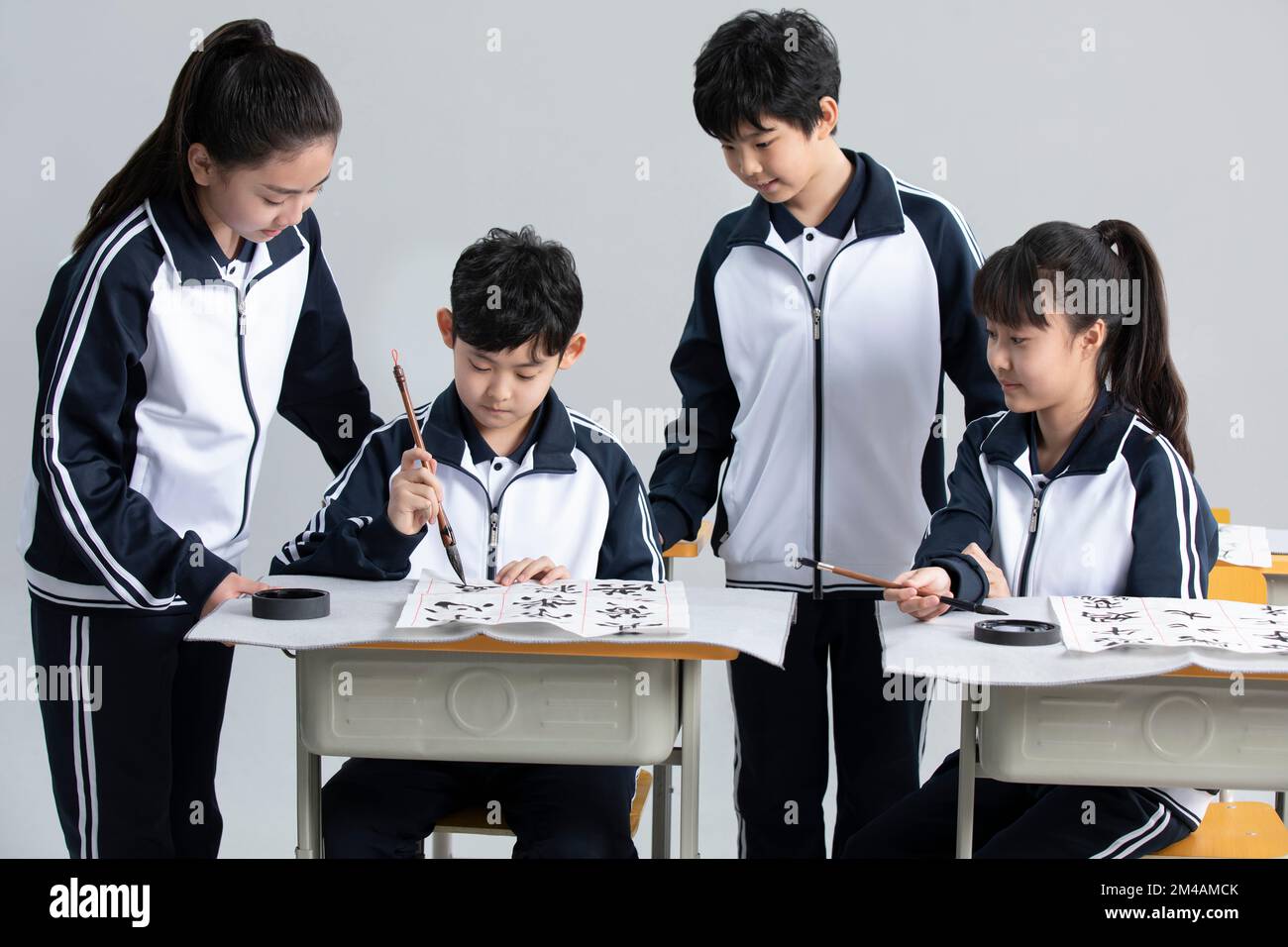 Chinese students practicing calligraphy in classroom Stock Photo - Alamy