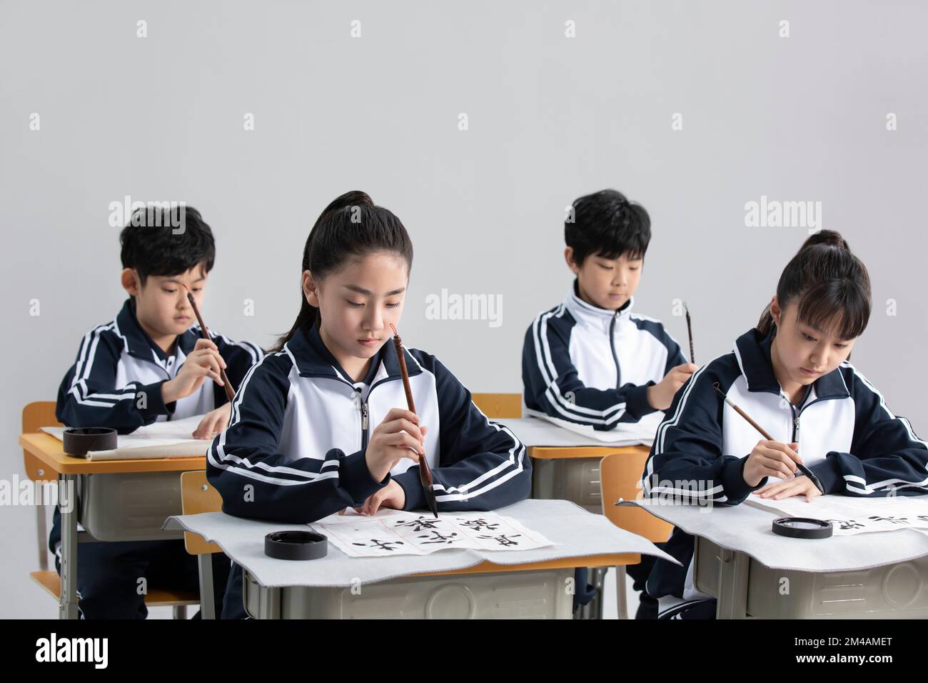 Chinese students practicing calligraphy in classroom Stock Photo - Alamy