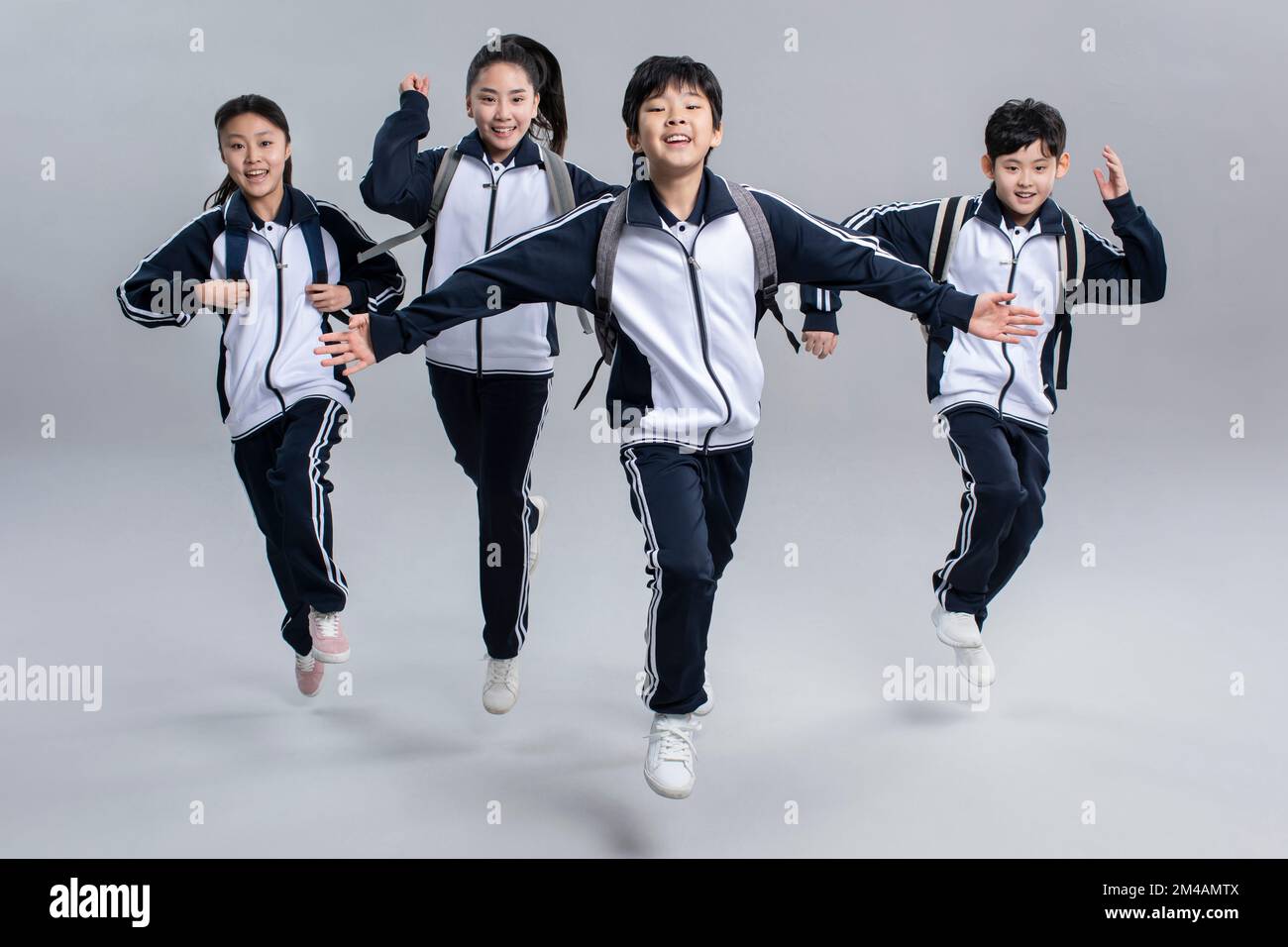 Cheerful students jumping arms hi-res stock photography and images - Alamy