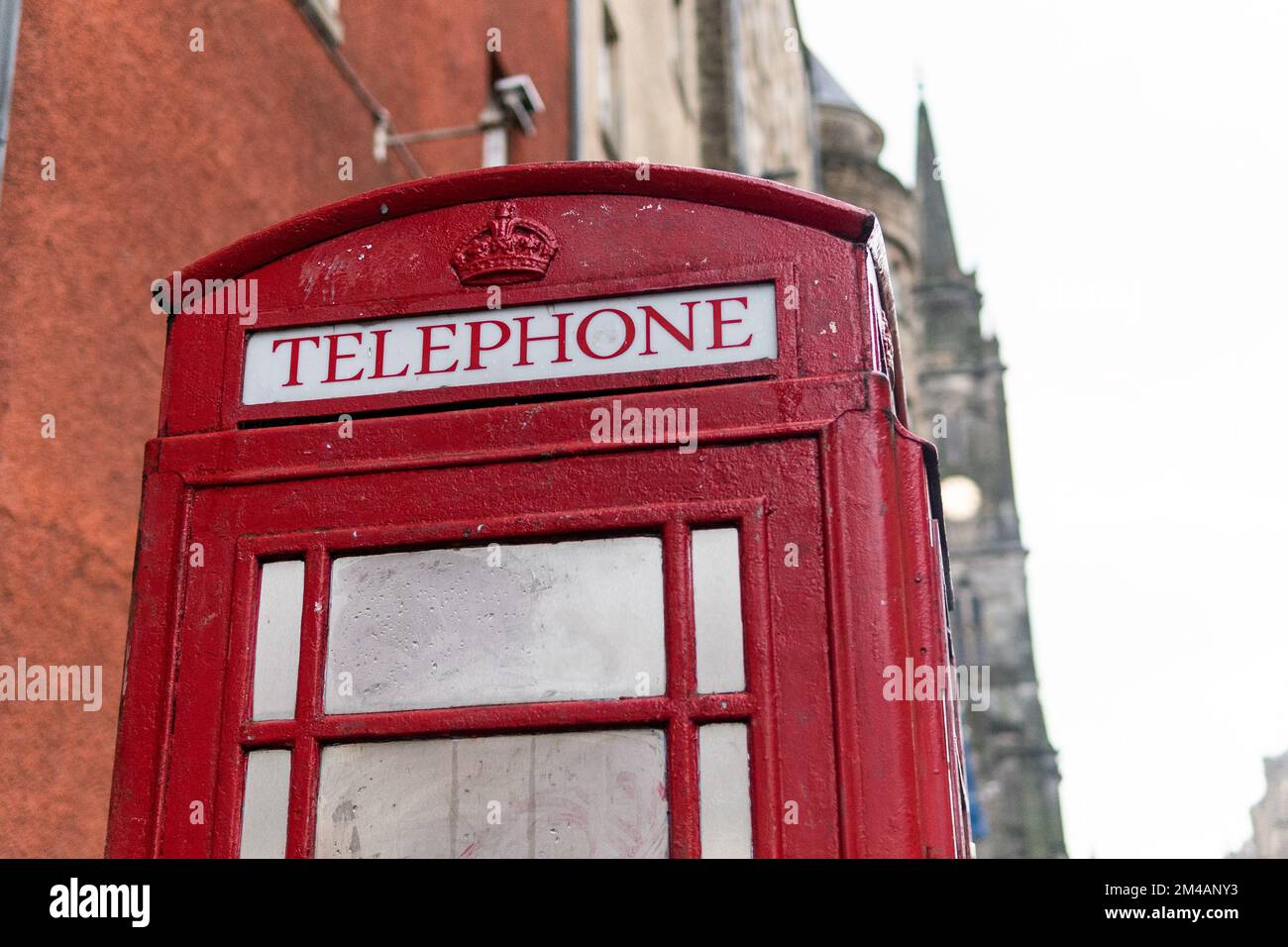 From below red telephone box with royal crown symbol located near old ...