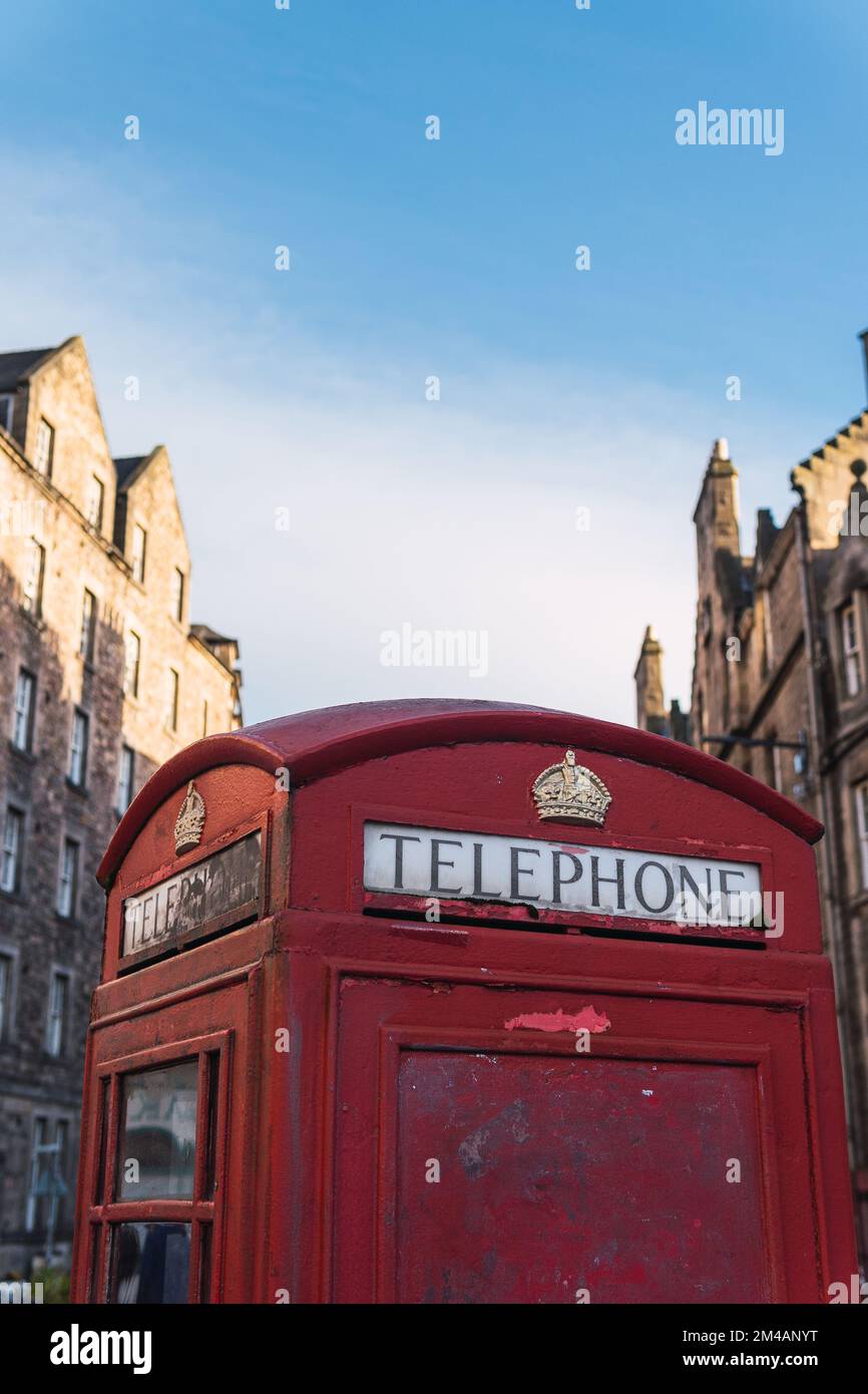 From below red telephone box with royal crown symbol located near old ...