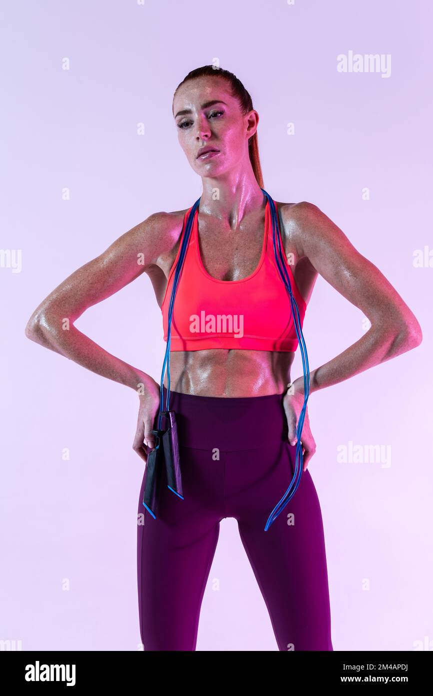 Female athlete with resistance band on neck looking away during break ...