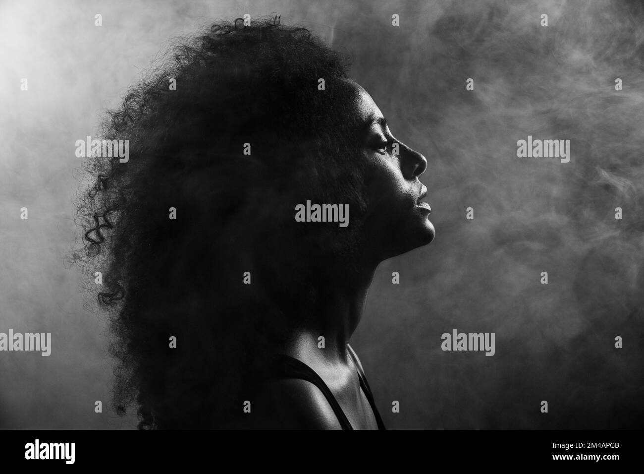 Black and white side view of dreamy African American female with Afro ...