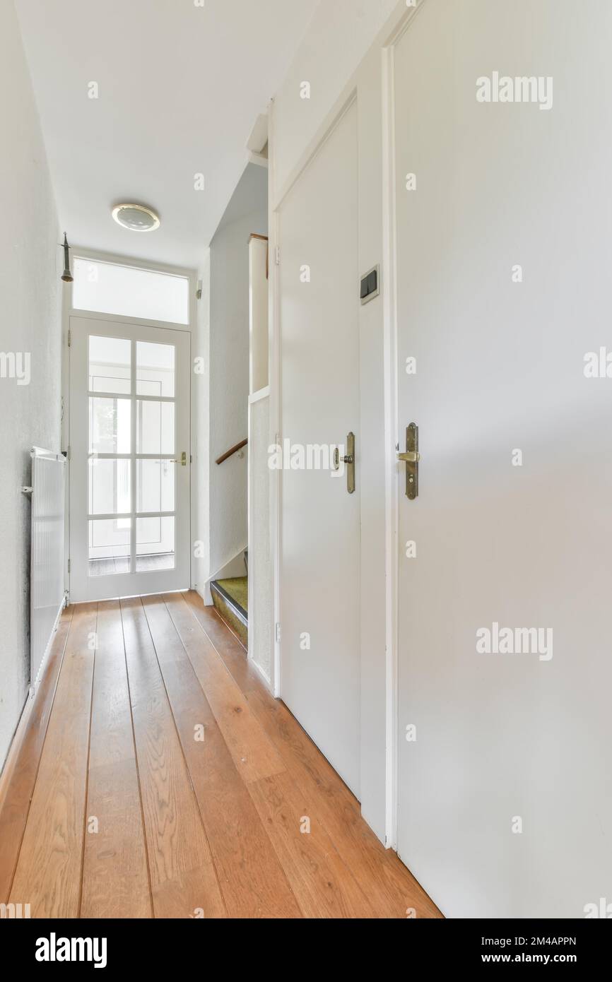 Interior passage way with parquet and white walls in modern house Stock ...