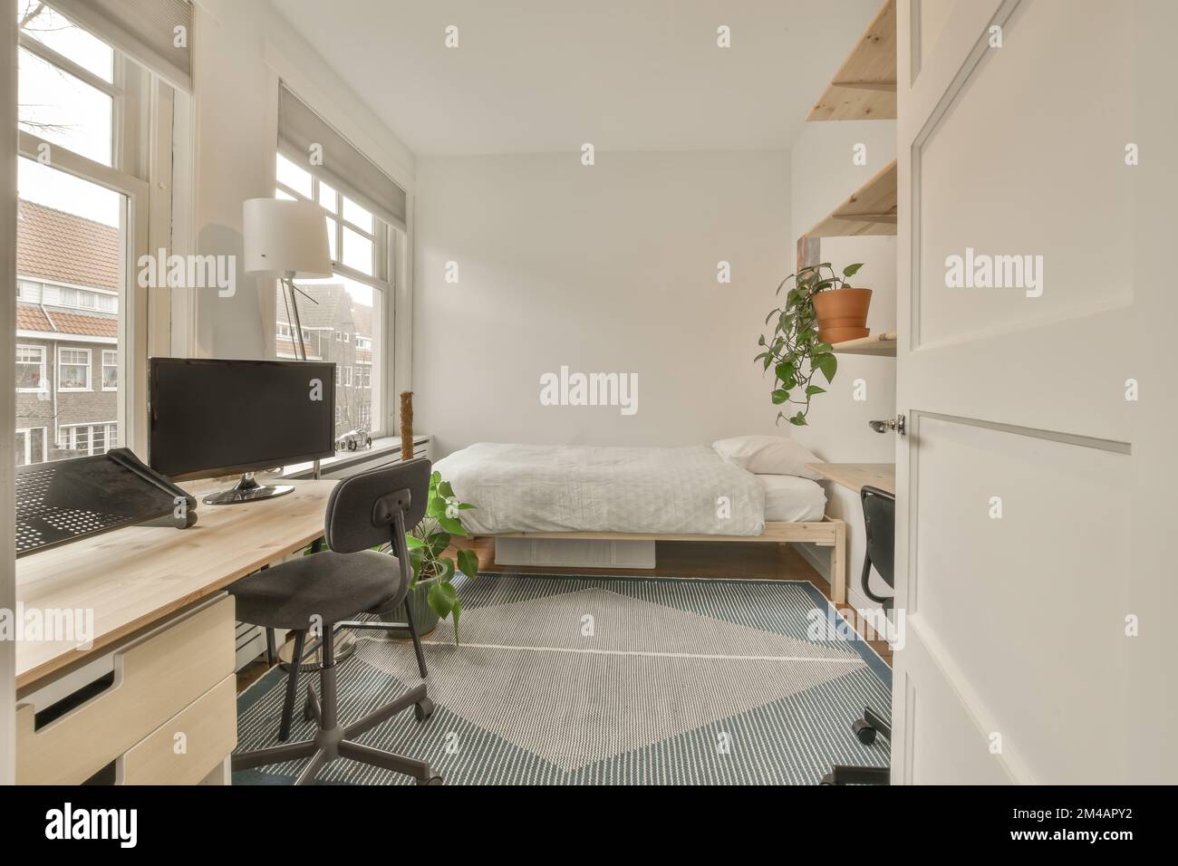 Interior of modern bedroom with comfortable bed and workspace with ...