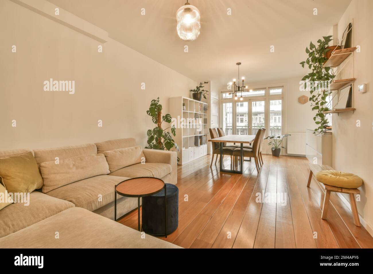 Interior of spacious open space room with lounge and dining zones in ...