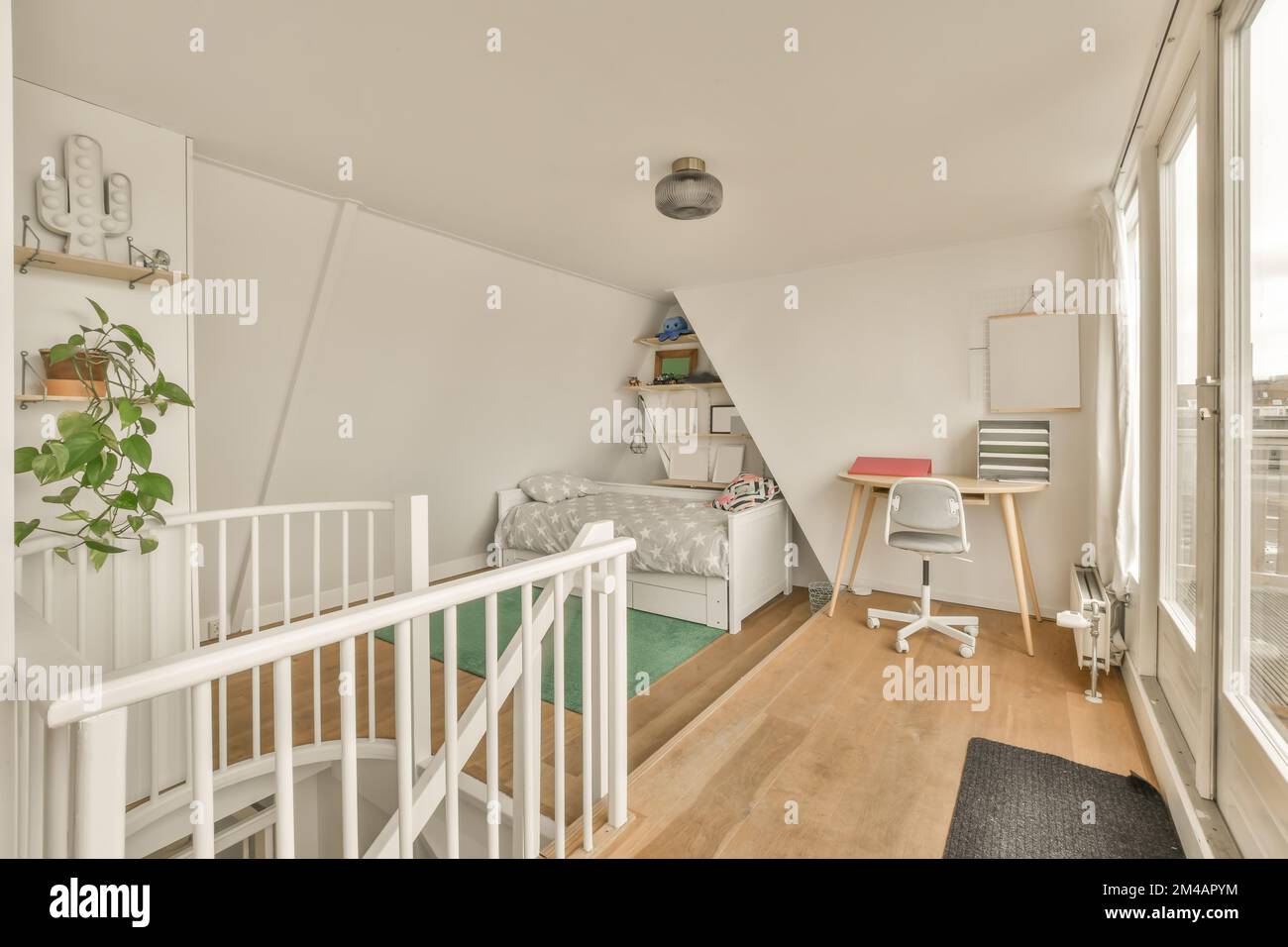 Interior of modern bedroom with workspace with computer and table lamp ...