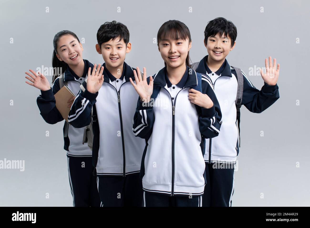 Cute children waving smiling camera hi-res stock photography and images ...