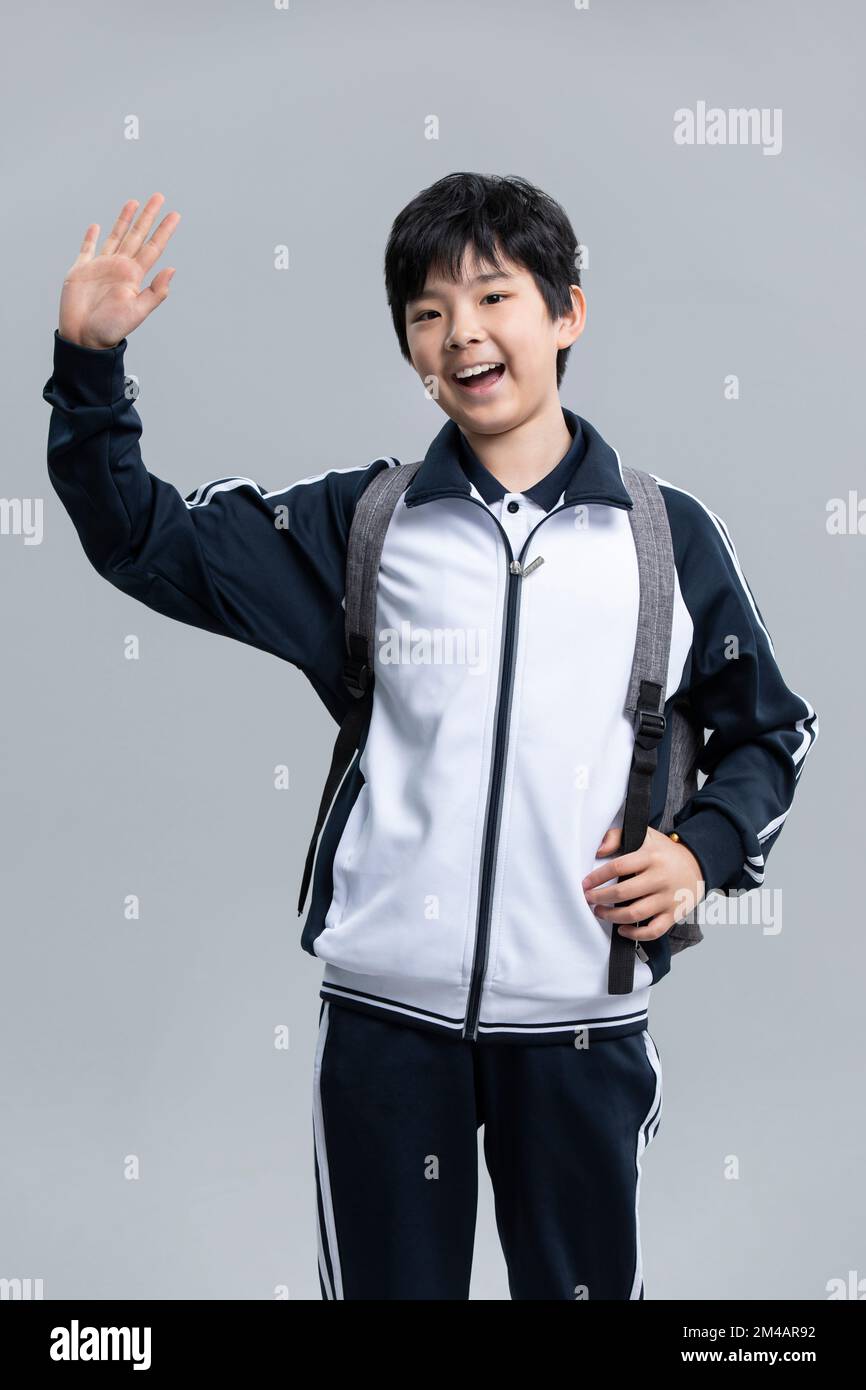 Student boy with school bag waving hand hi-res stock photography and ...