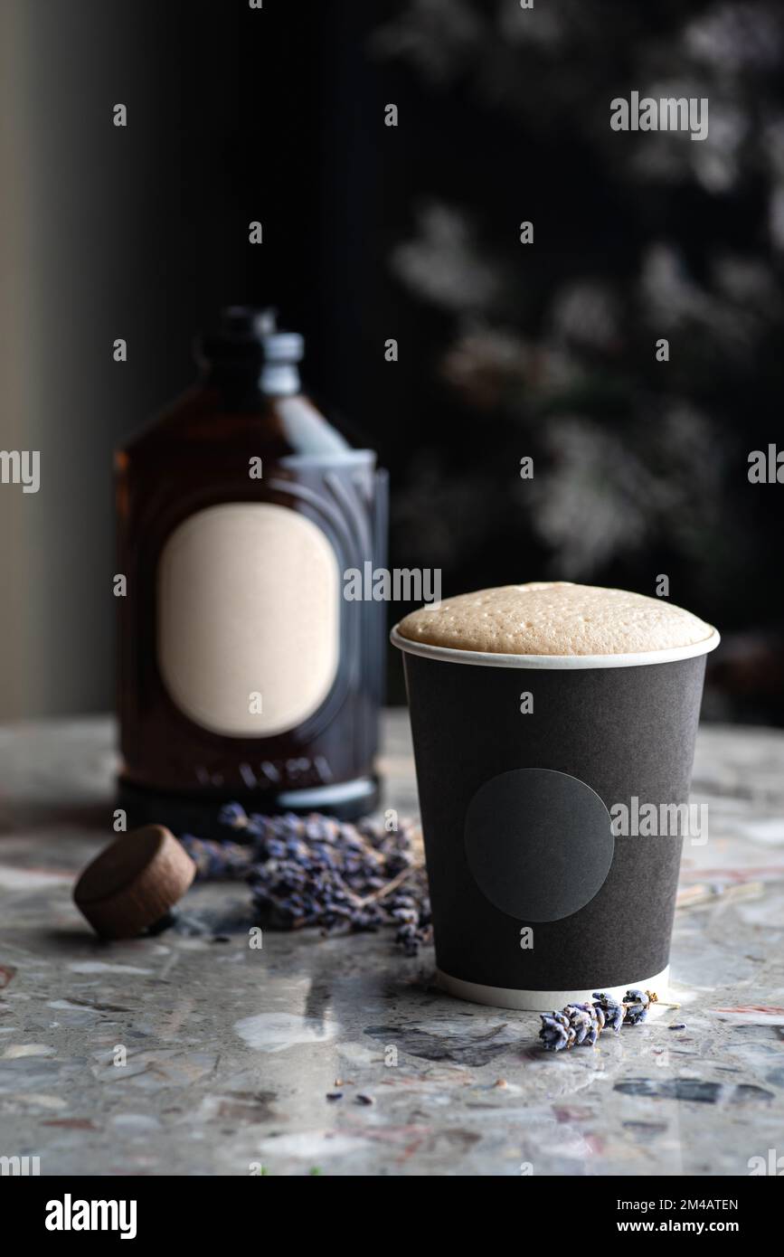 Cappuccino in a paper Cup on a marble table, with lavender flavor ...