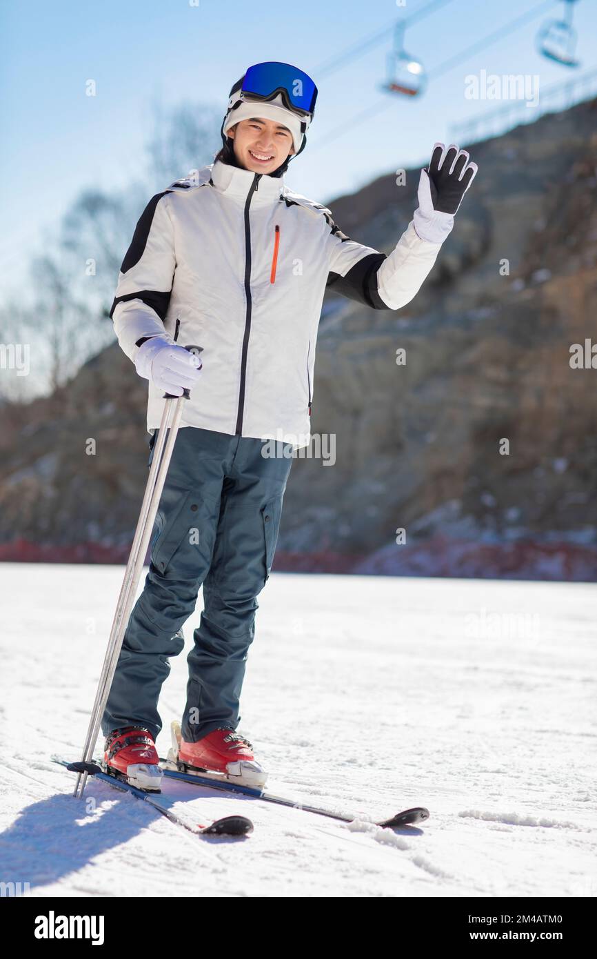 Young Chinese man skiing in ski resort Stock Photo - Alamy