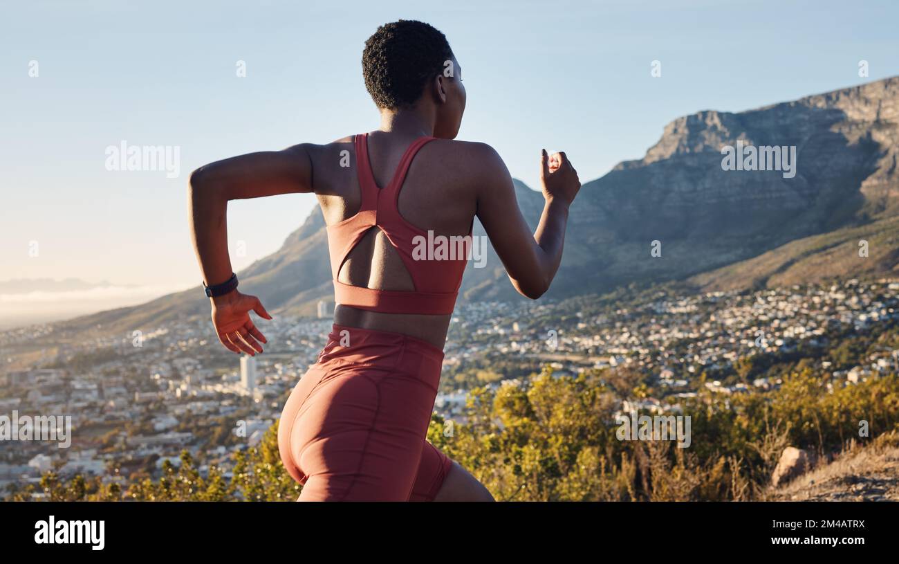 Back, black woman and running in nature, workout and training for ...