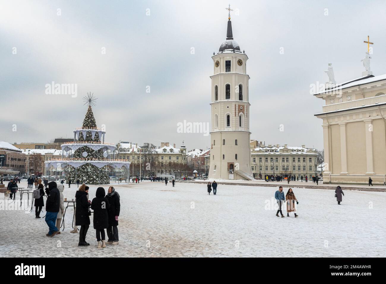 Beautiful Christmas tree in a big cake with snow, people and tourists ...
