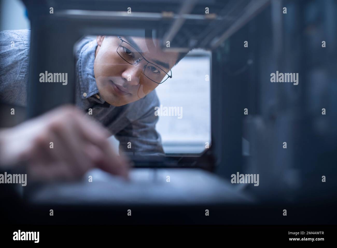 Confident Chinese designer using a 3D printer Stock Photo - Alamy