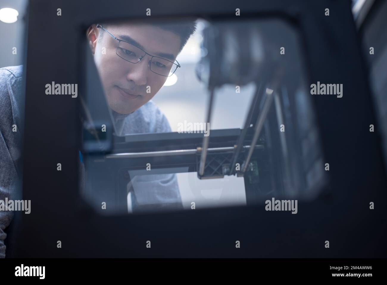 Confident Chinese designer using a 3D printer Stock Photo - Alamy