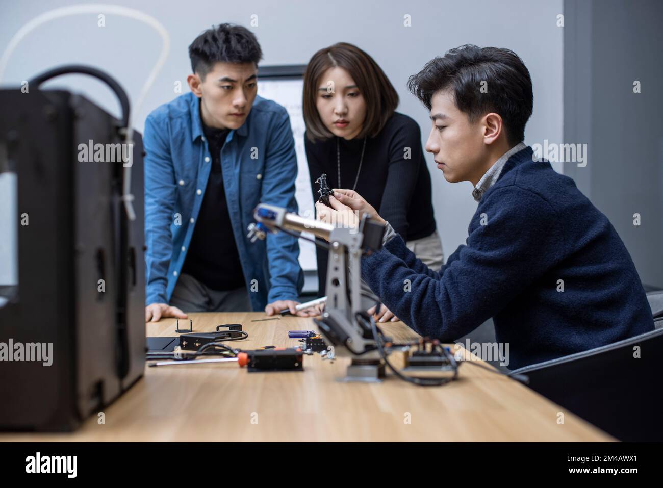 Confident Chinese designers using a 3D printer Stock Photo - Alamy