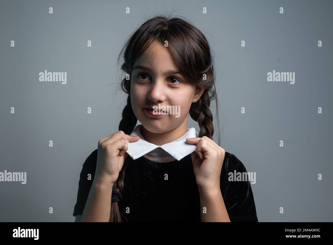 Portrait of little girl with Wednesday Addams costume during Halloween ...