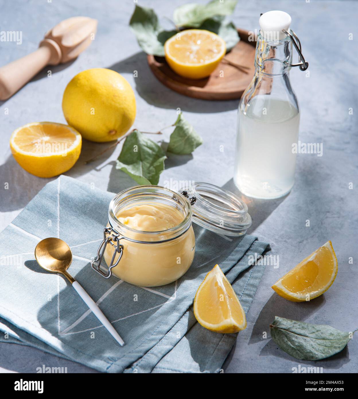 Delicious homemade lemon curd in a glass jar with lemon slices and ...