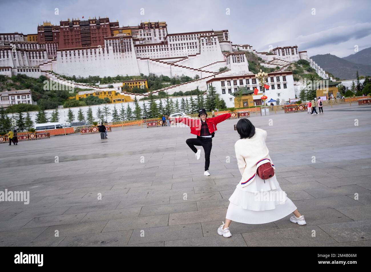 Two chinese young girls pose for a photograph in front of the Potala ...