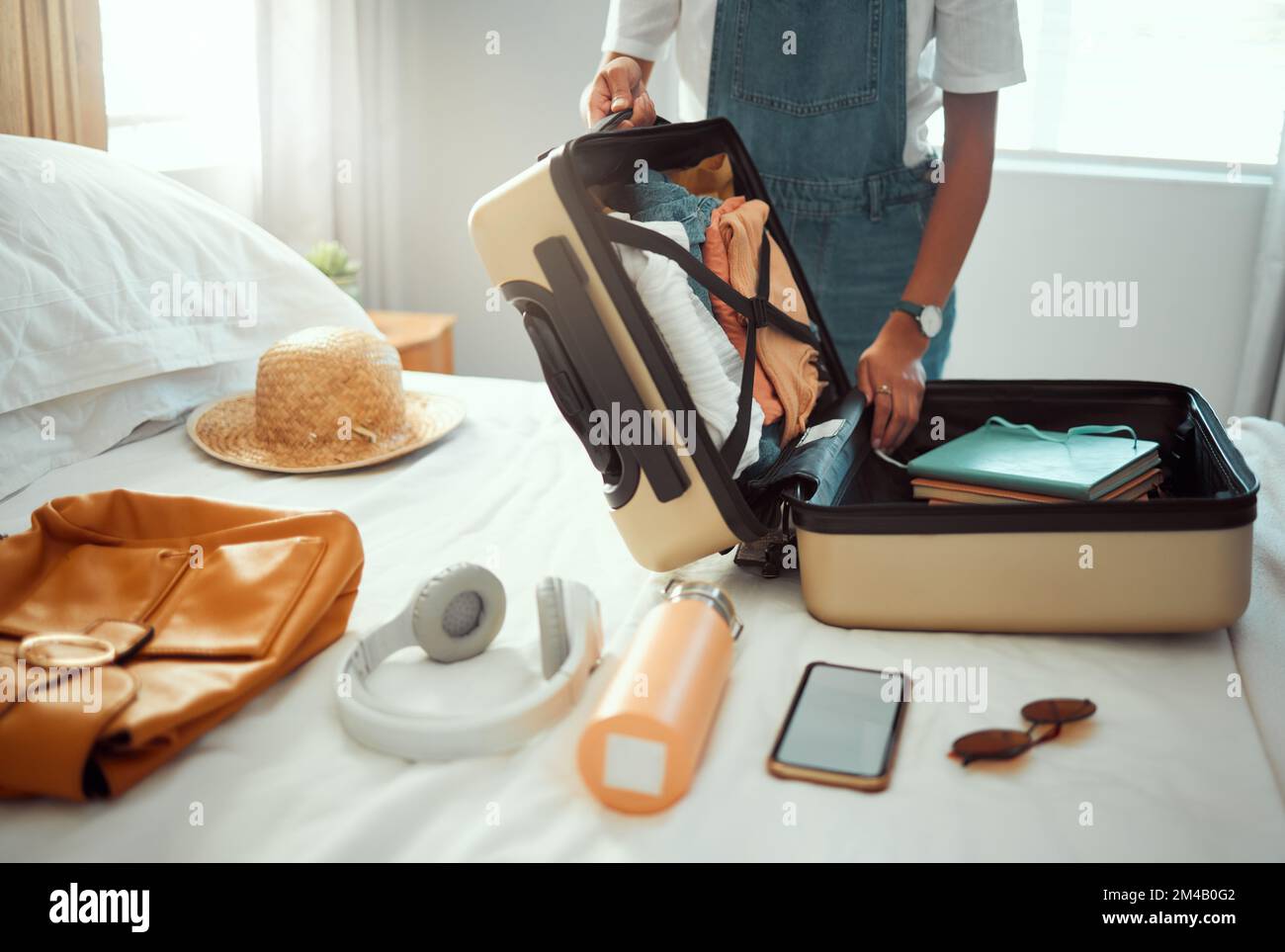 Suitcase, woman and packing clothes, bag and luggage for travel ...