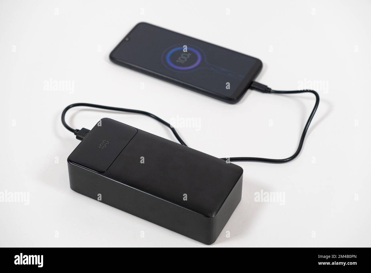 Connecting a mobile phone to a power bank. Charging gadgets from power ...